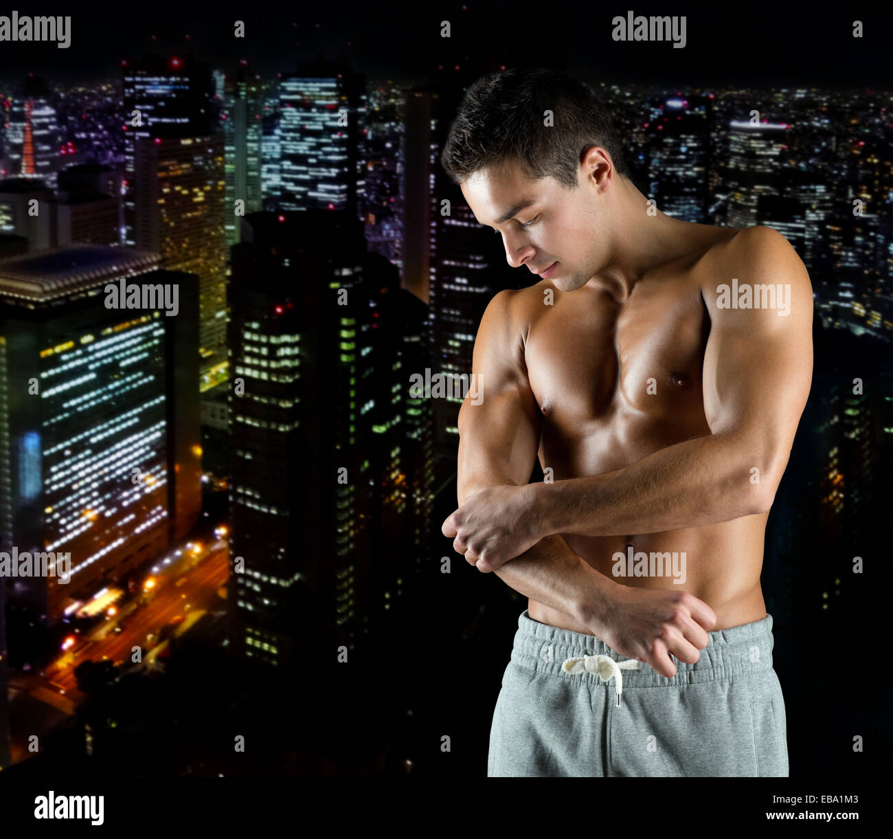 young male bodybuilder injured touching elbow Stock Photo - Alamy