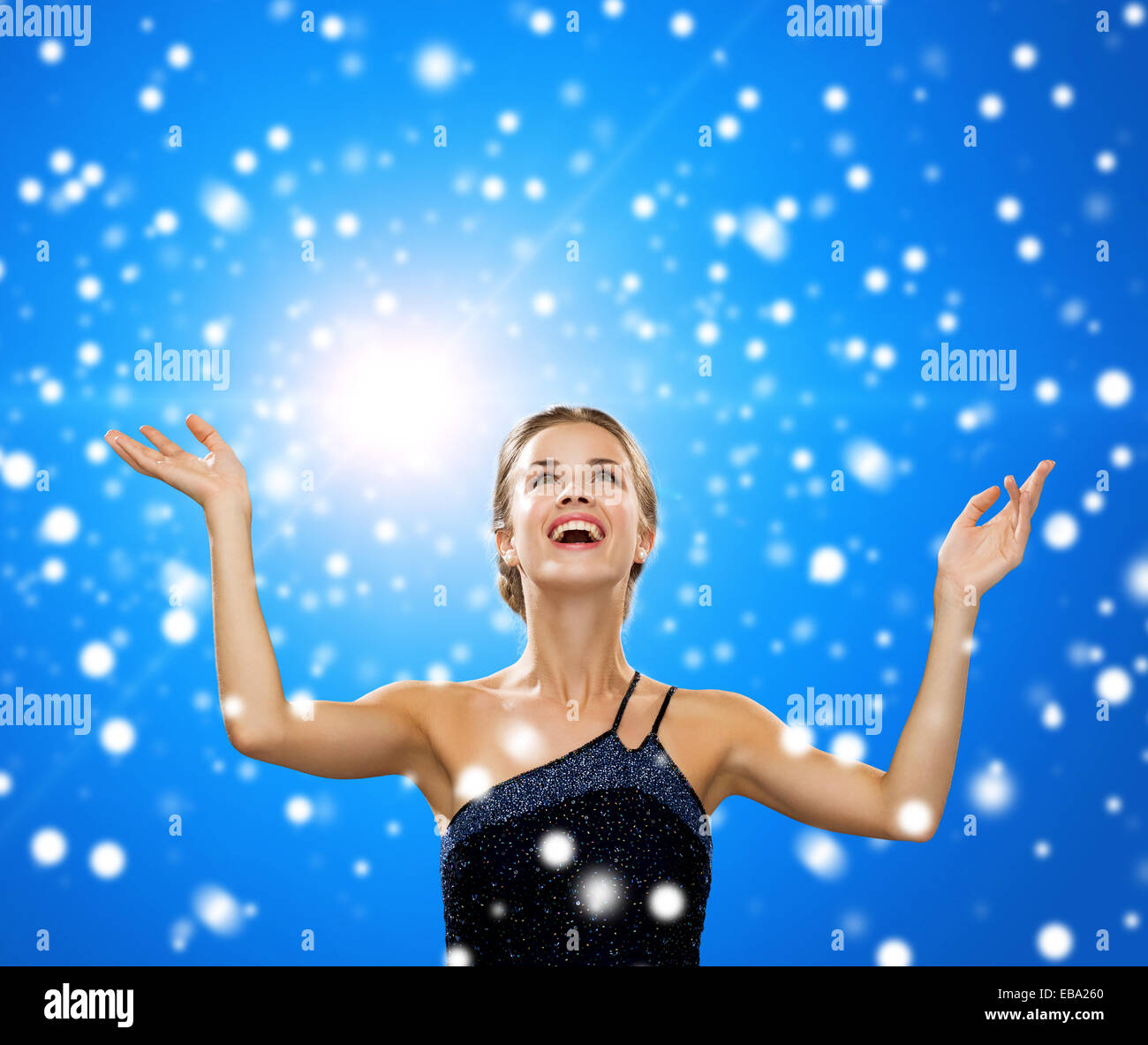 smiling woman raising hands and looking up Stock Photo - Alamy