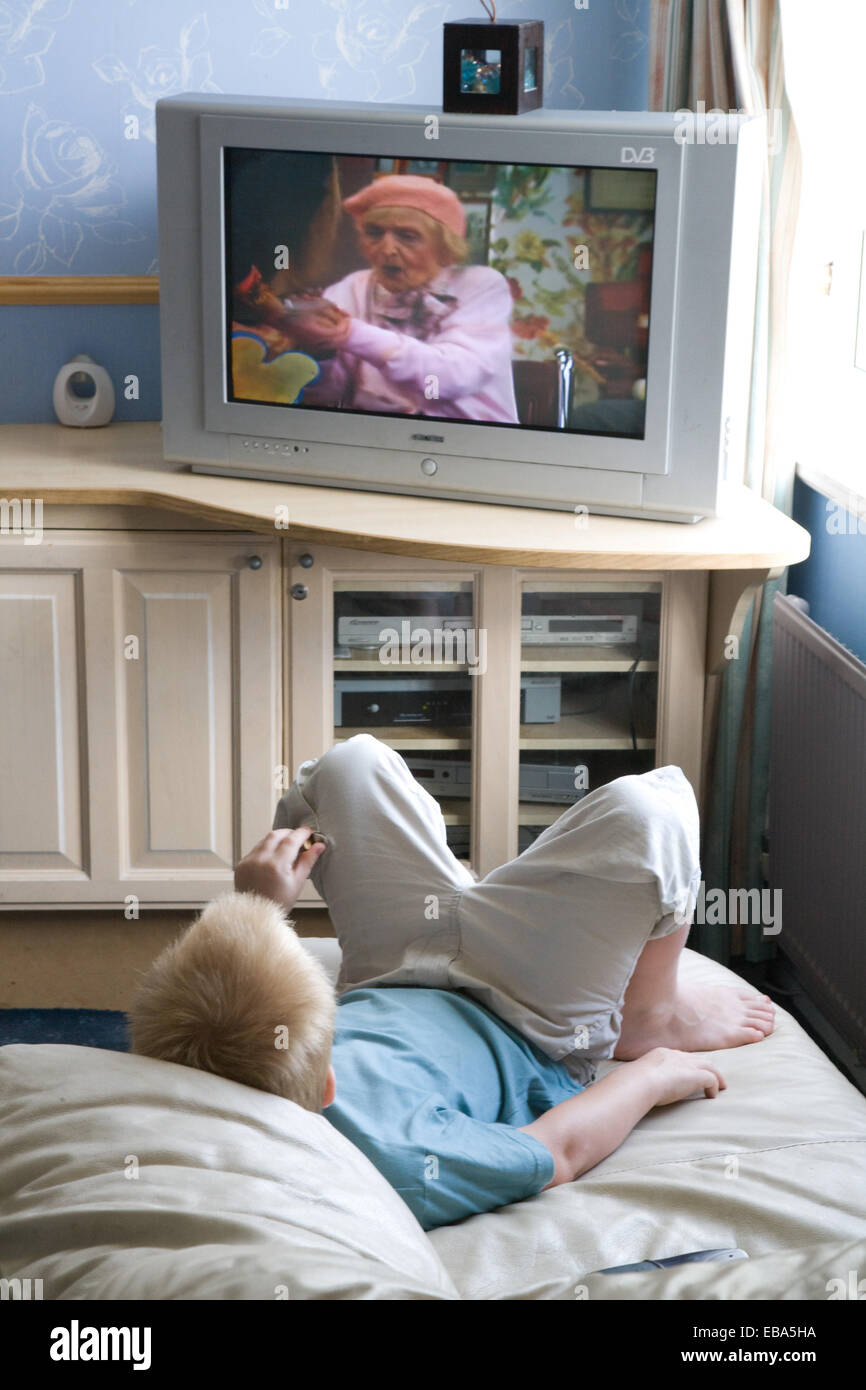 Little boy watching TV at home Stock Photo - Alamy