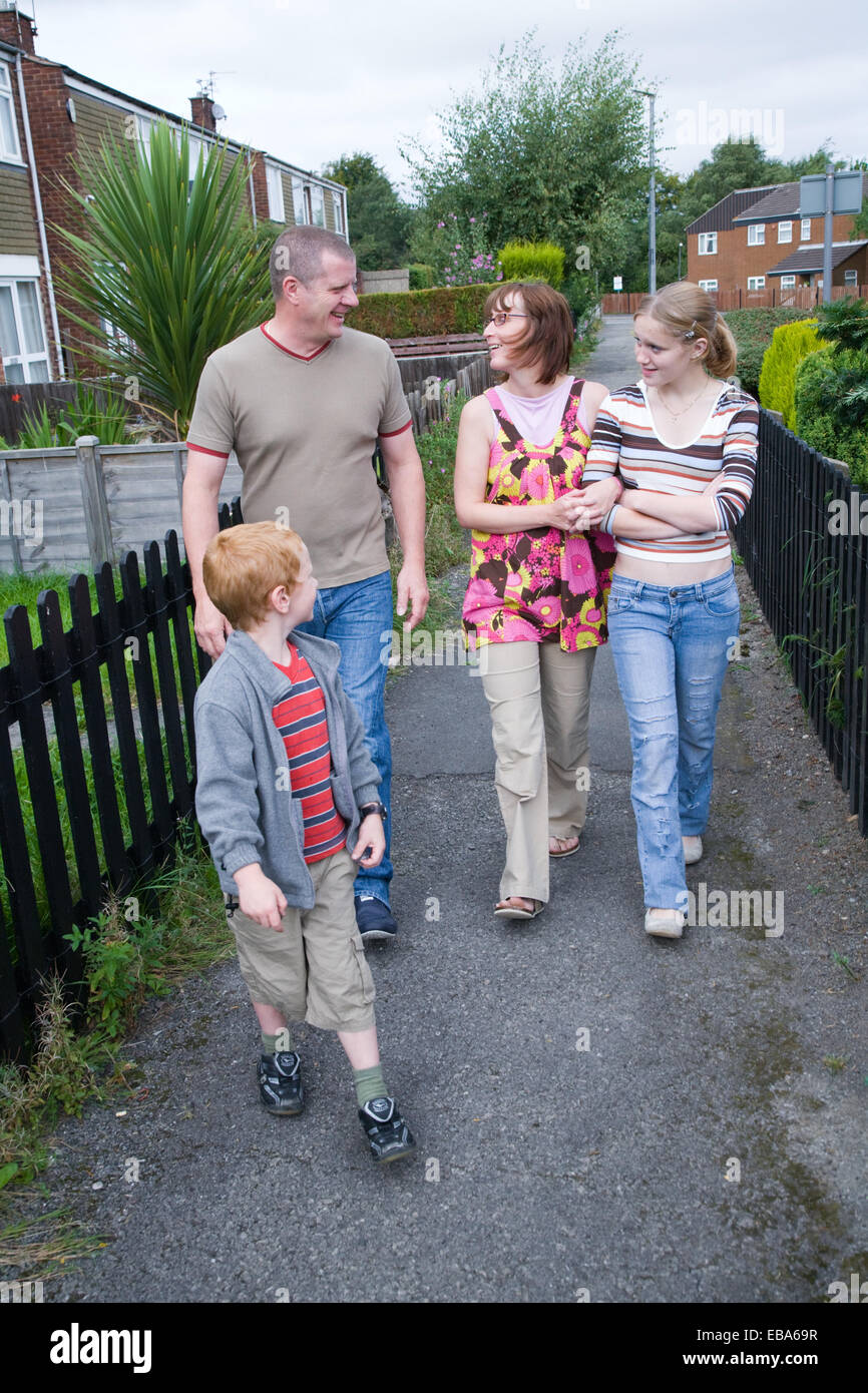 Family out walking down the street Stock Photo - Alamy