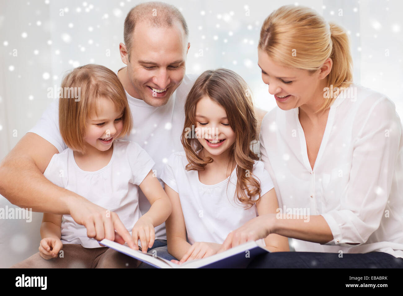 happy family with book at home Stock Photo - Alamy