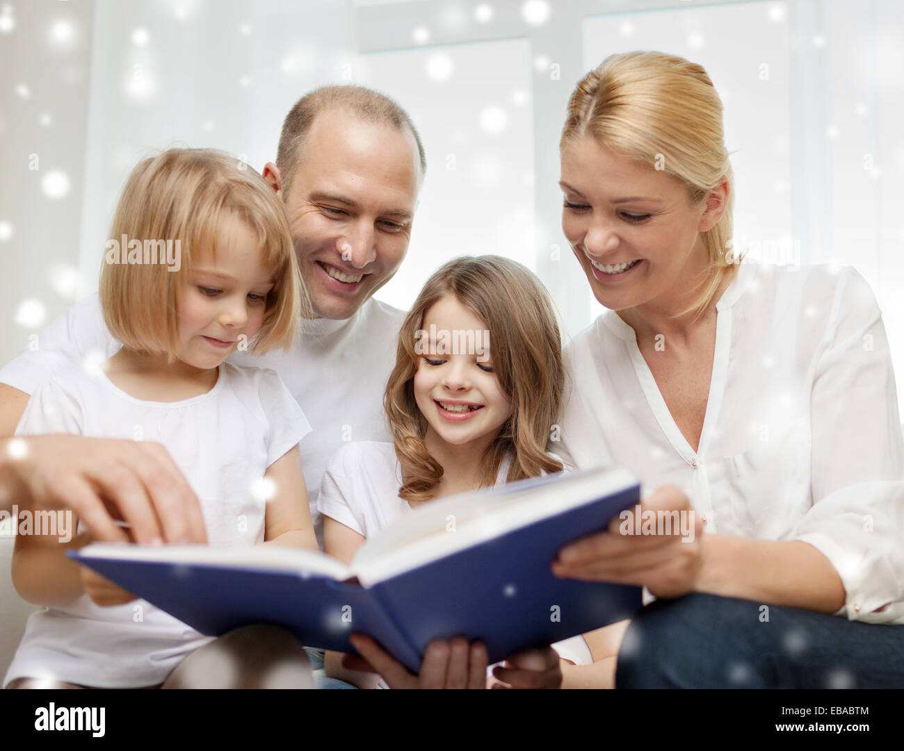 happy family with book at home Stock Photo - Alamy