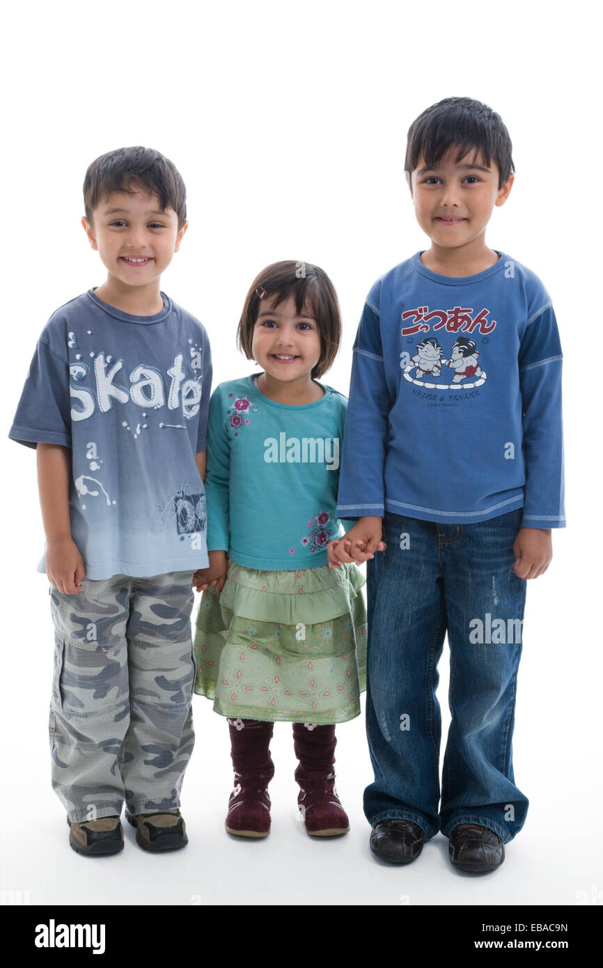 Portrait of three children smiling in the studio Stock Photo - Alamy