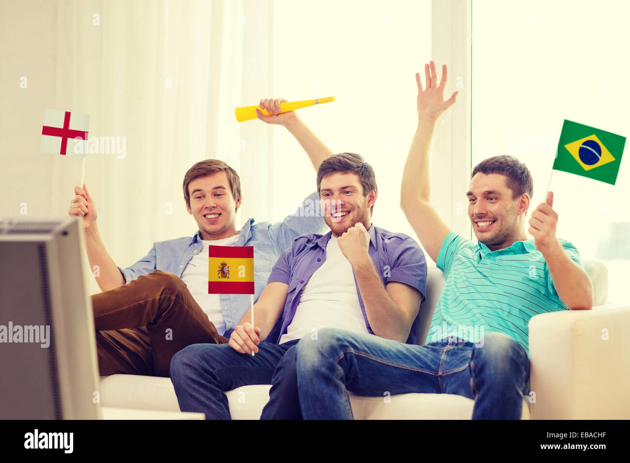 happy male friends with flags and vuvuzela Stock Photo - Alamy