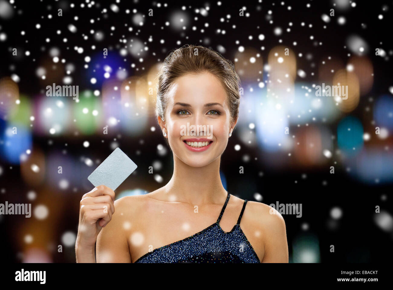smiling woman in evening dress holding credit card Stock Photo - Alamy