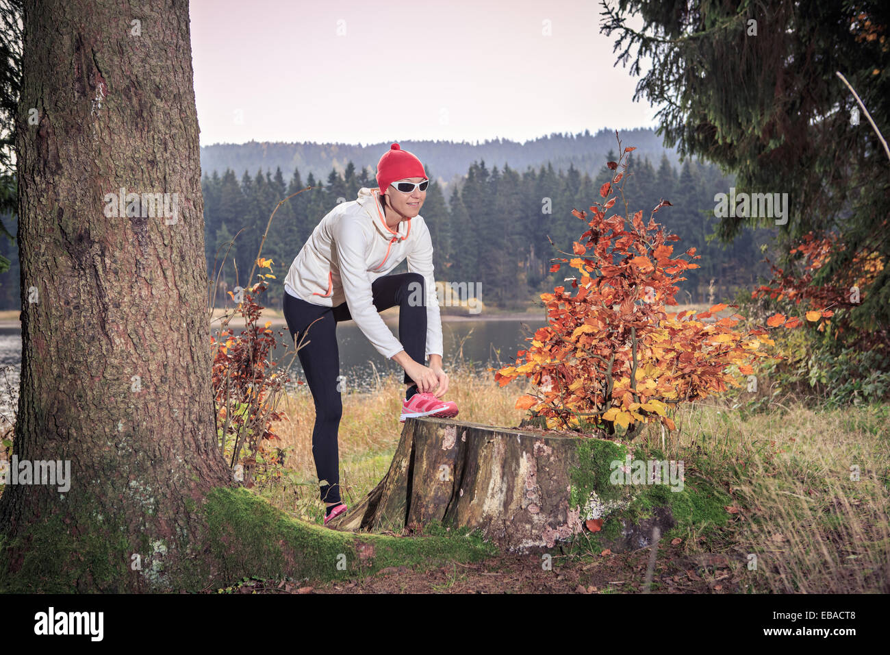 woman running through the forest by the lake Stock Photo - Alamy