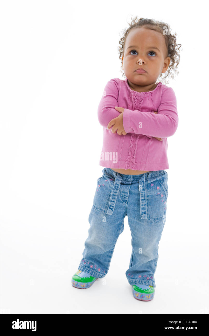 Portrait of a little girl looking grumpy in the studio Stock Photo - Alamy