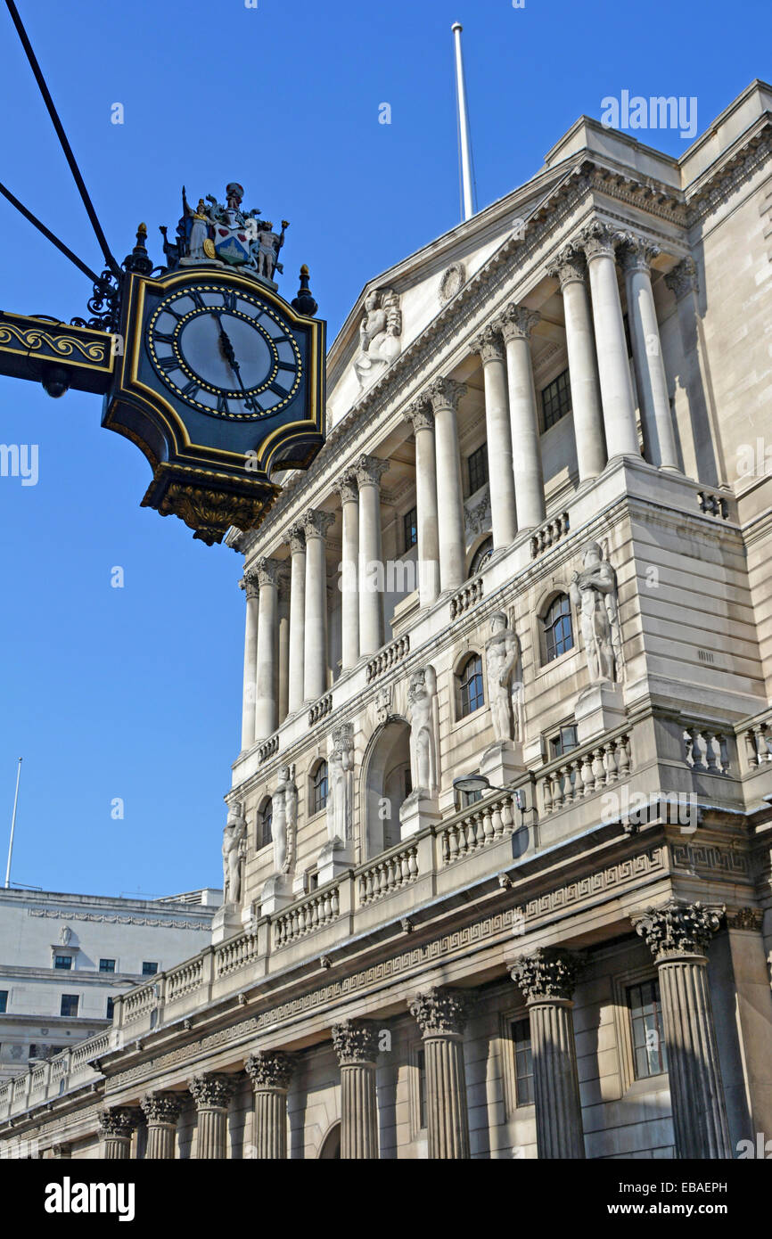 Ornate clock face on side of Royal Exchange building with colonnades of ...
