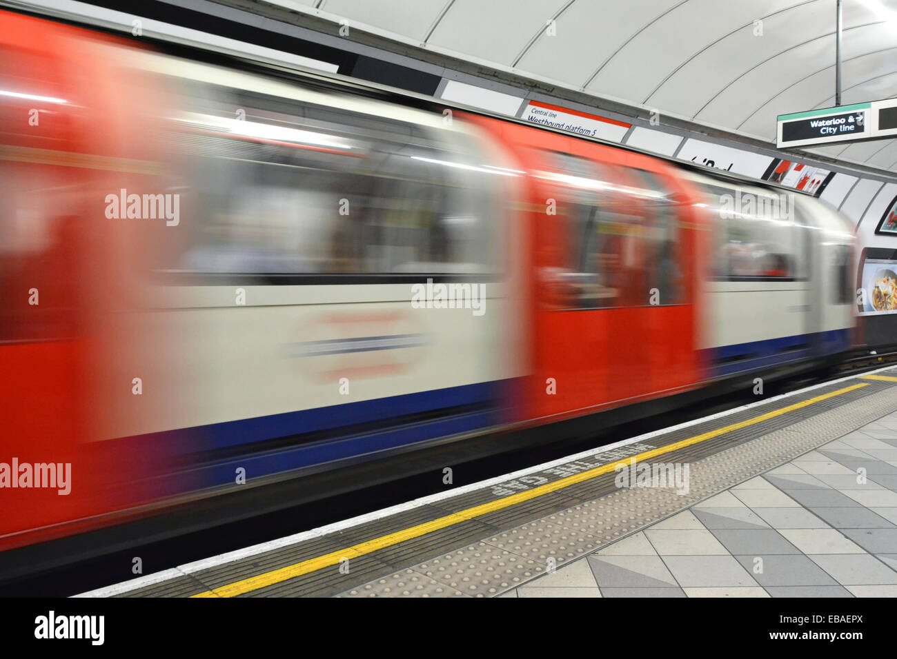 Empty platform on London Underground with motion blur tube train ...
