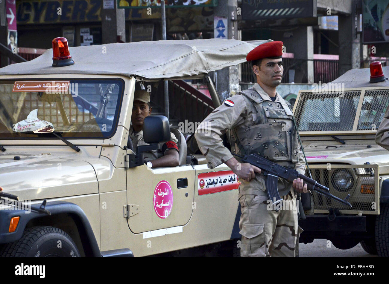 Cairo, Egypt. 28th Nov, 2014. Egyptian security forces stand guard in ...