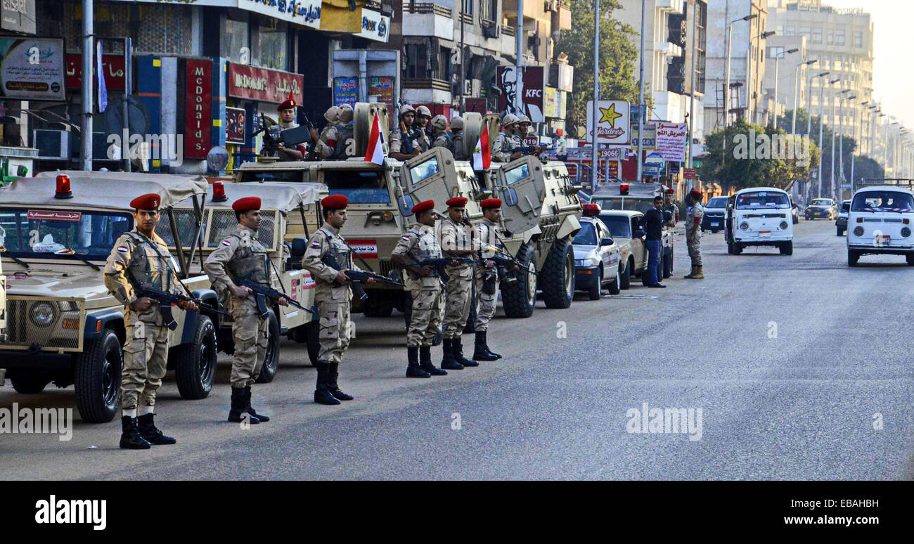 Cairo, Egypt. 28th Nov, 2014. Egyptian security forces stand guard in ...