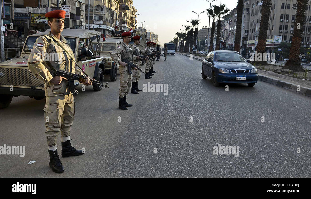 Cairo, Egypt. 28th Nov, 2014. Egyptian security forces stand guard in ...