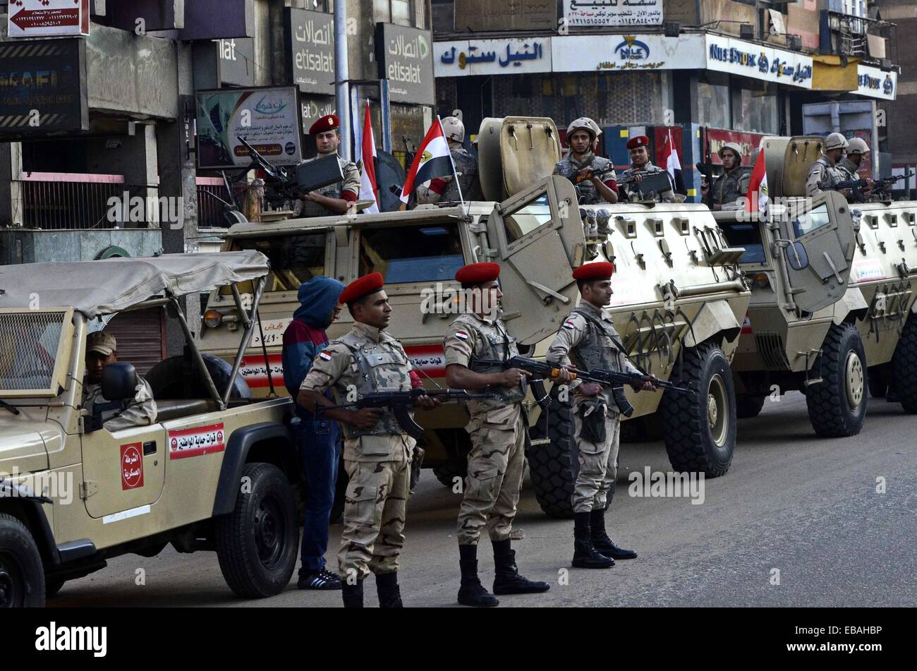 Cairo, Egypt. 28th Nov, 2014. Egyptian security forces stand guard in ...