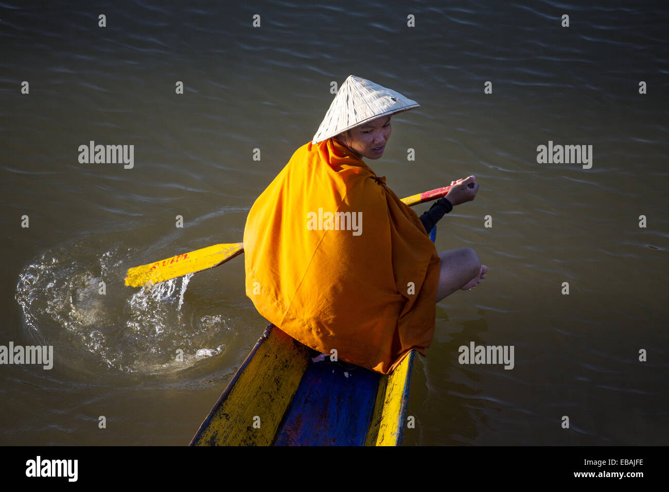 Buddhist monks on a row boat on the Mekong River in Paske, Laos Stock ...