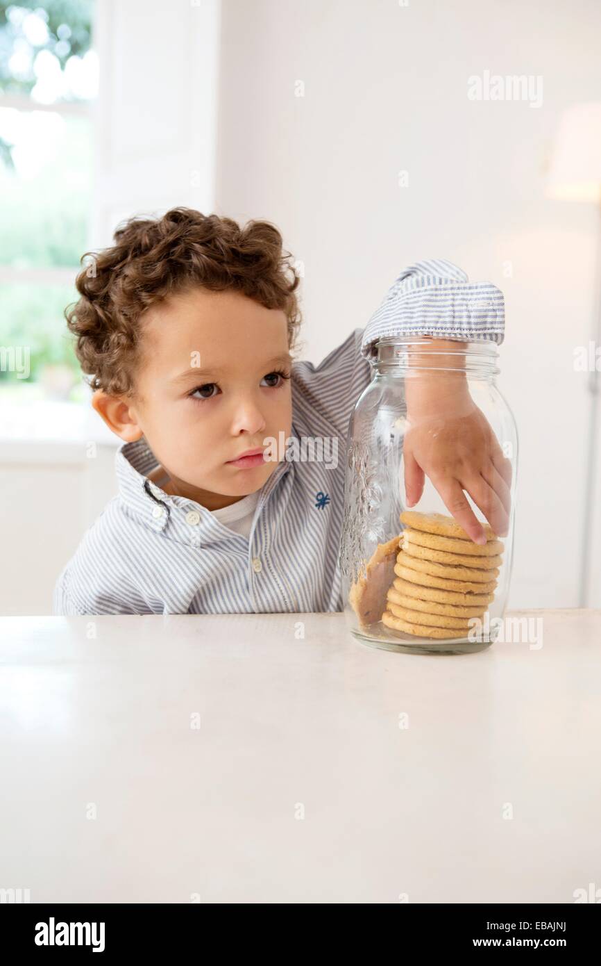 Child sneaking food hi-res stock photography and images - Alamy