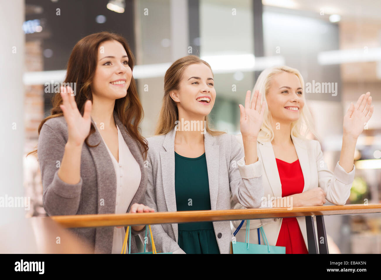 happy young women with shopping bags in mall Stock Photo - Alamy