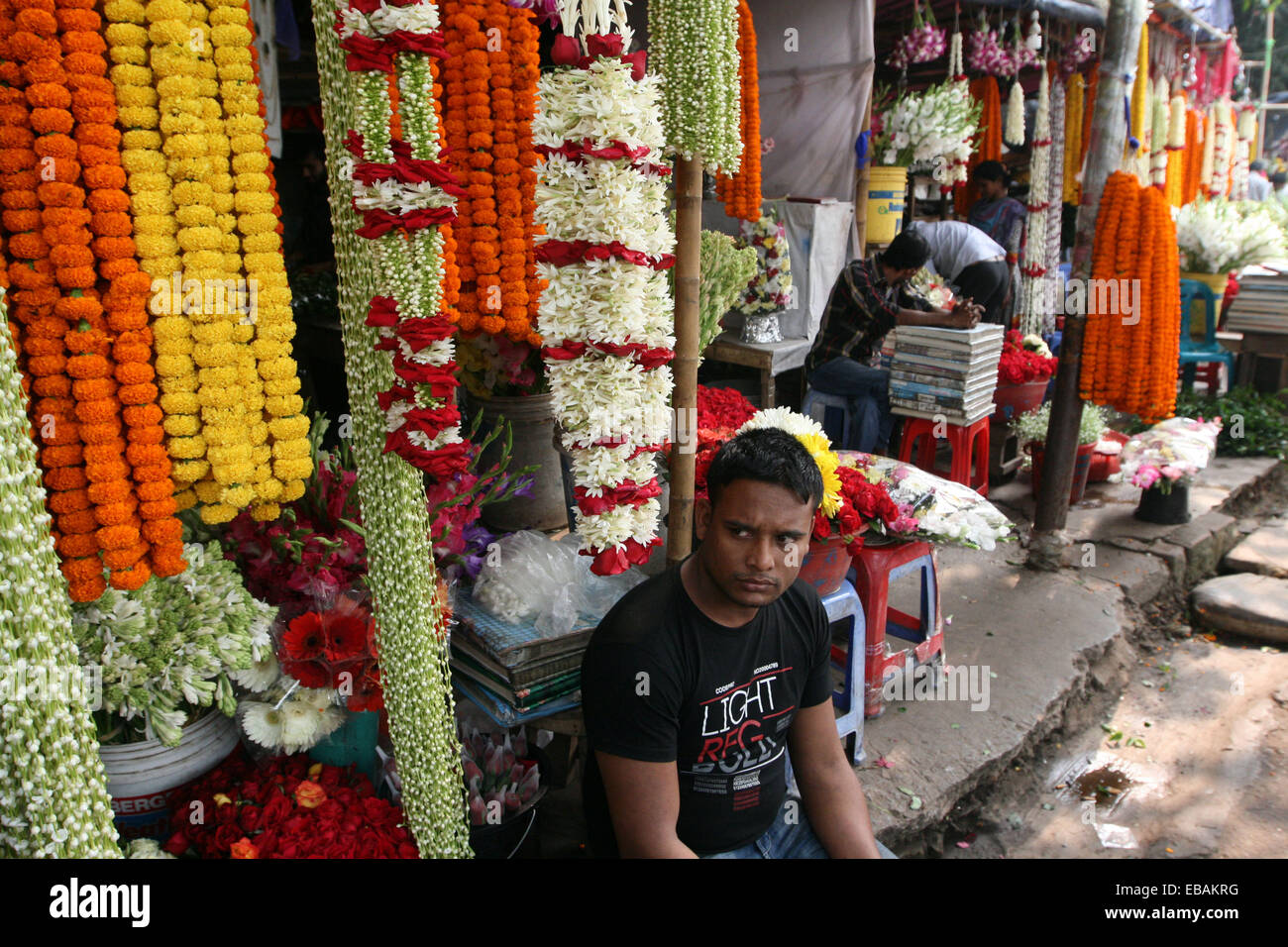 November 2014. Flower vendor at his stall in the flower market in Dhaka ...