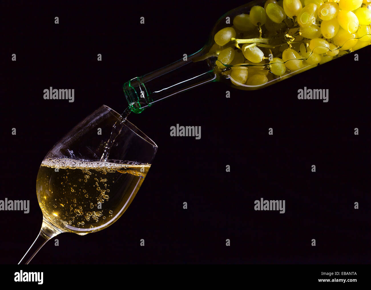 White wine being poured into a wineglass Stock Photo - Alamy