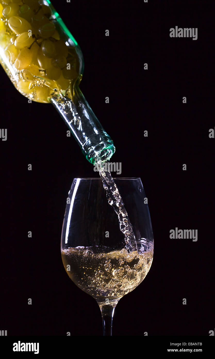 White wine being poured into a wineglass Stock Photo - Alamy