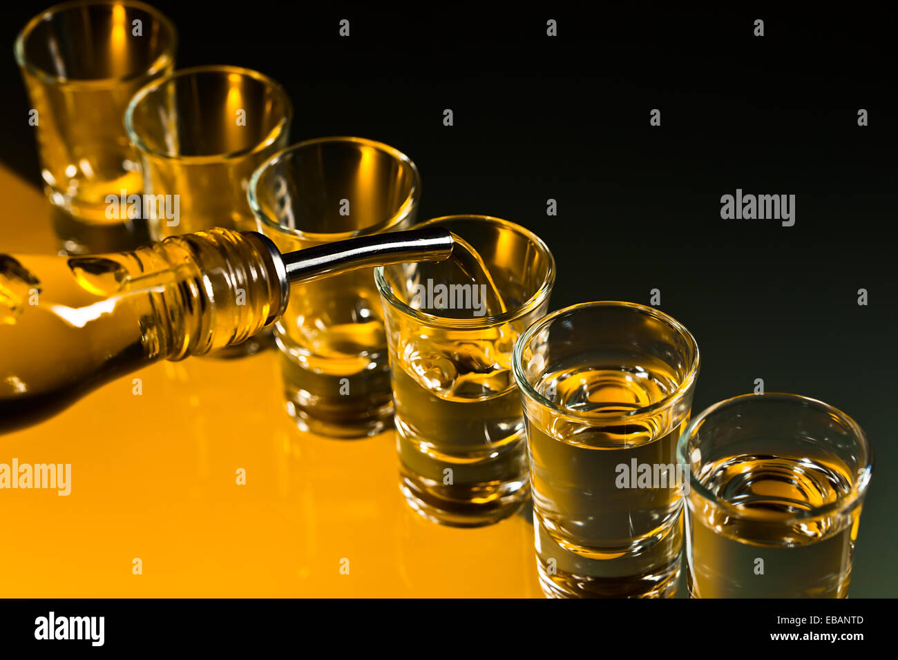 Glasses with an alcoholic drink on a glass table Stock Photo - Alamy