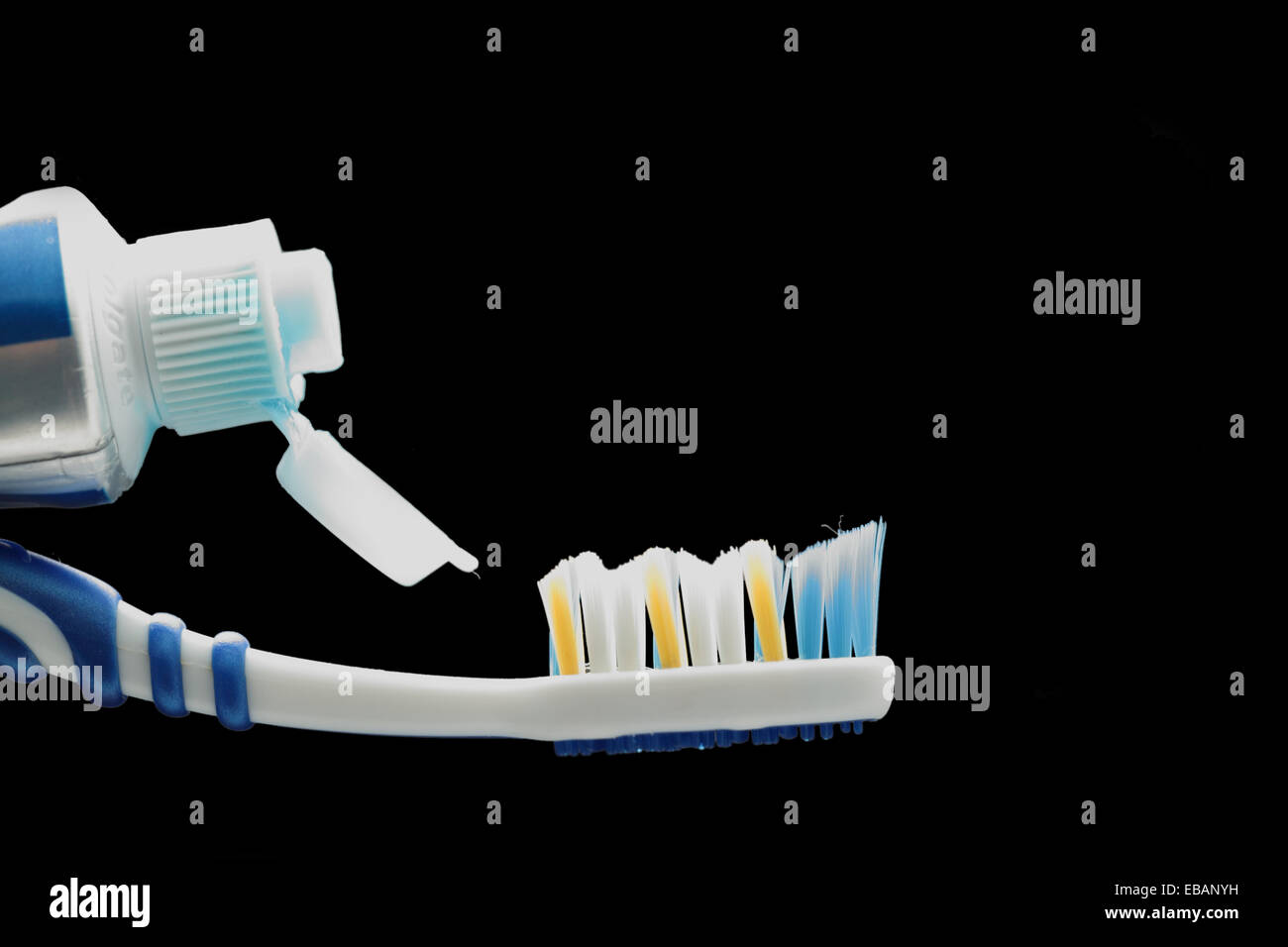 toothpaste and brushes on a black background Stock Photo - Alamy