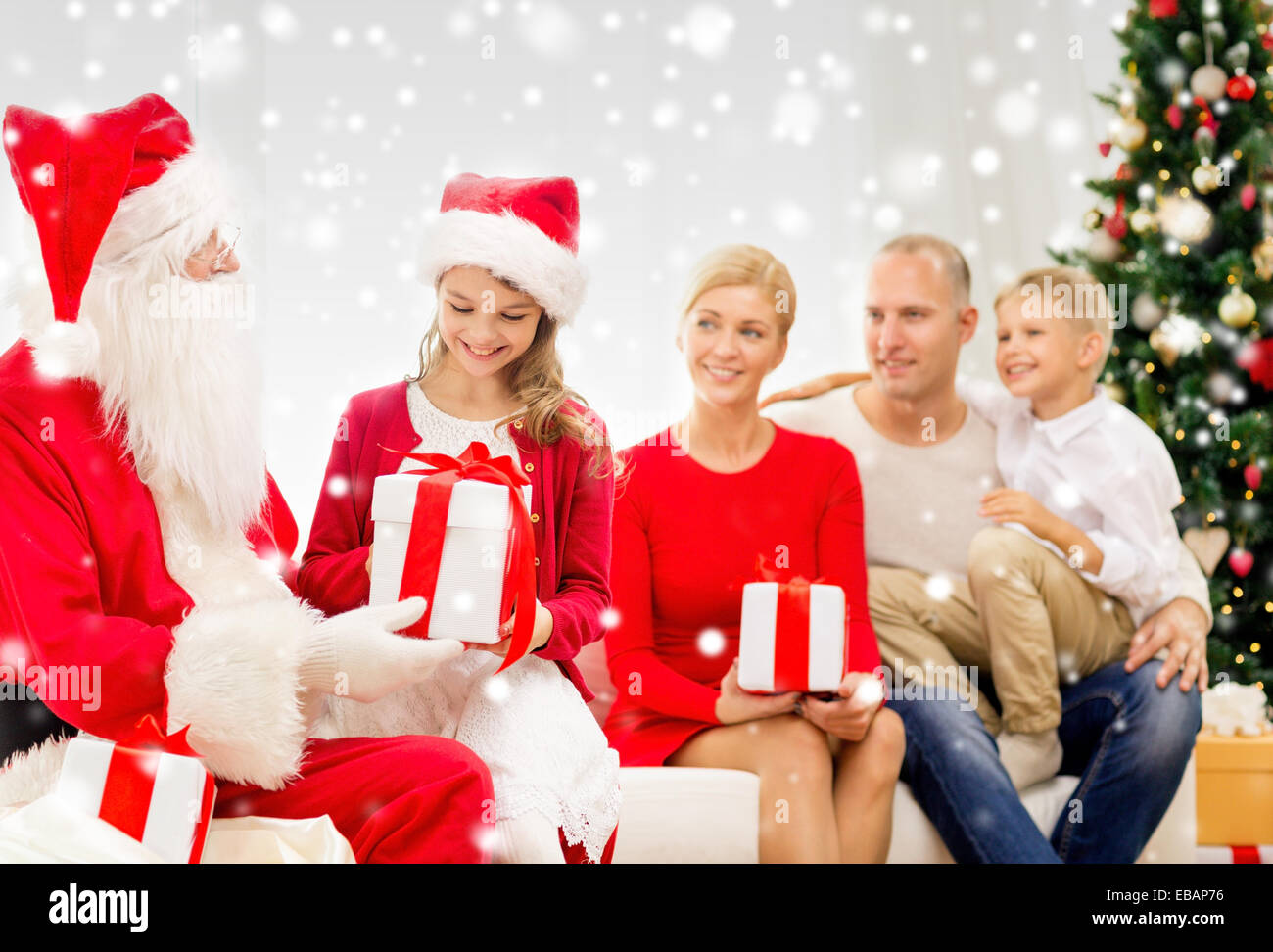 Children giving christmas presents parents hi-res stock photography and ...