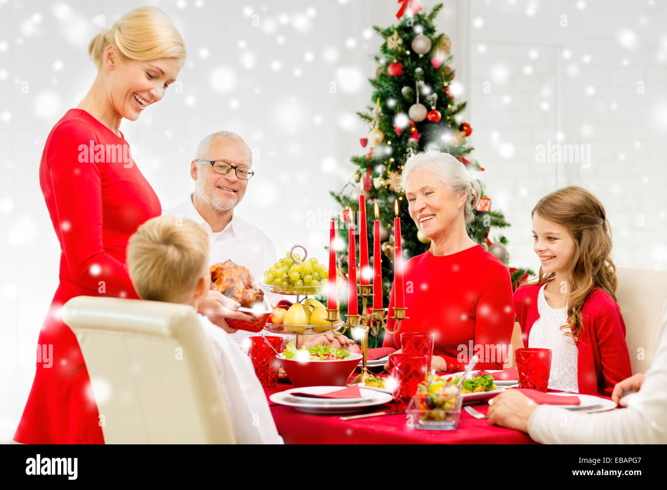 smiling family having holiday dinner at home Stock Photo - Alamy