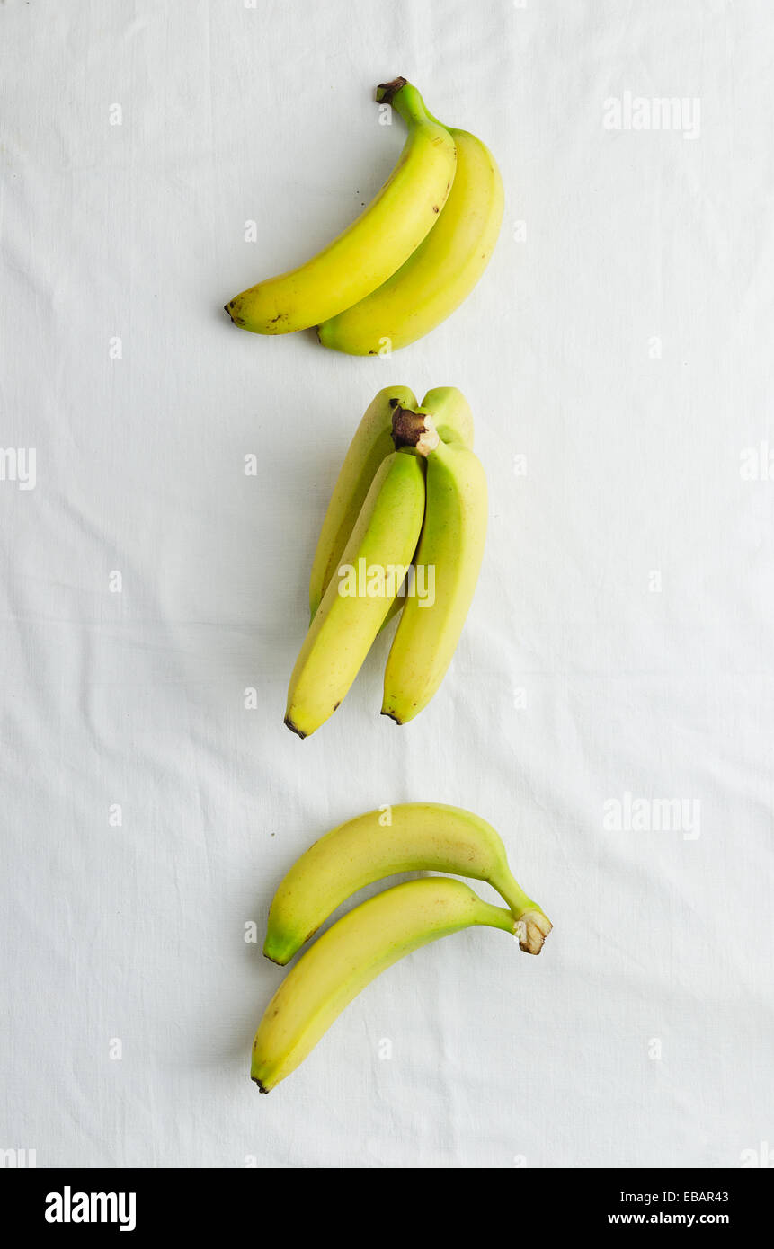 Multiple bananas over white cloth, above view Stock Photo - Alamy