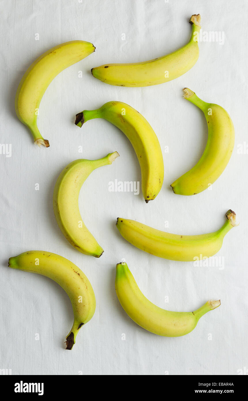 Multiple bananas over white cloth, above view Stock Photo - Alamy