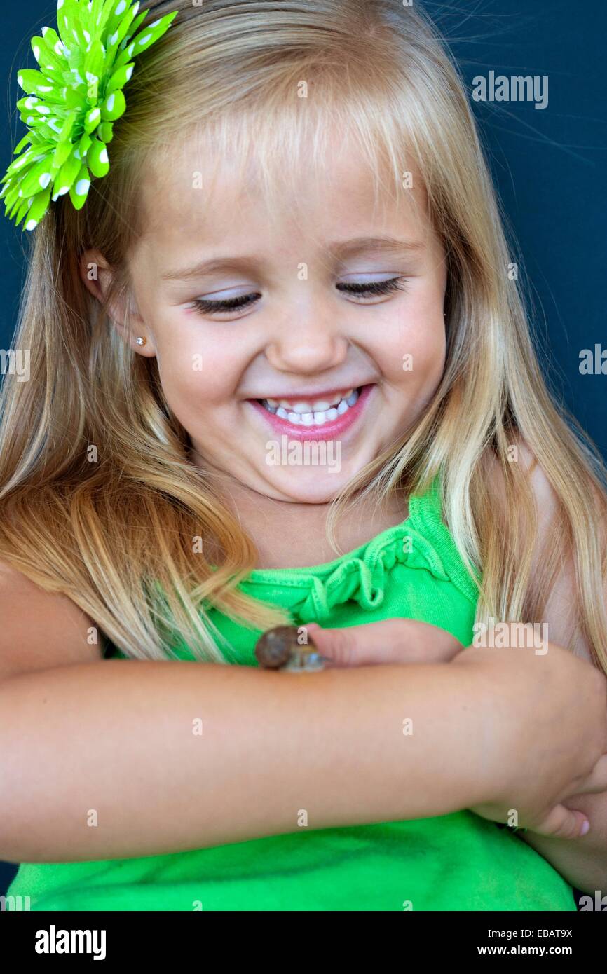 Young girl playing with a snail Stock Photo - Alamy