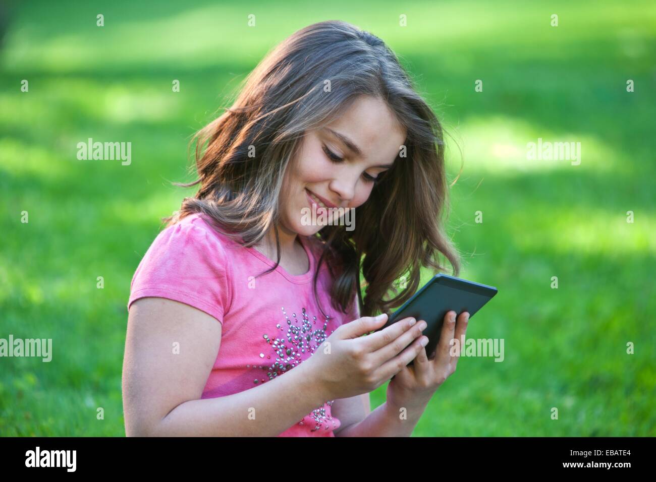 Young girl reading e-reader Stock Photo - Alamy