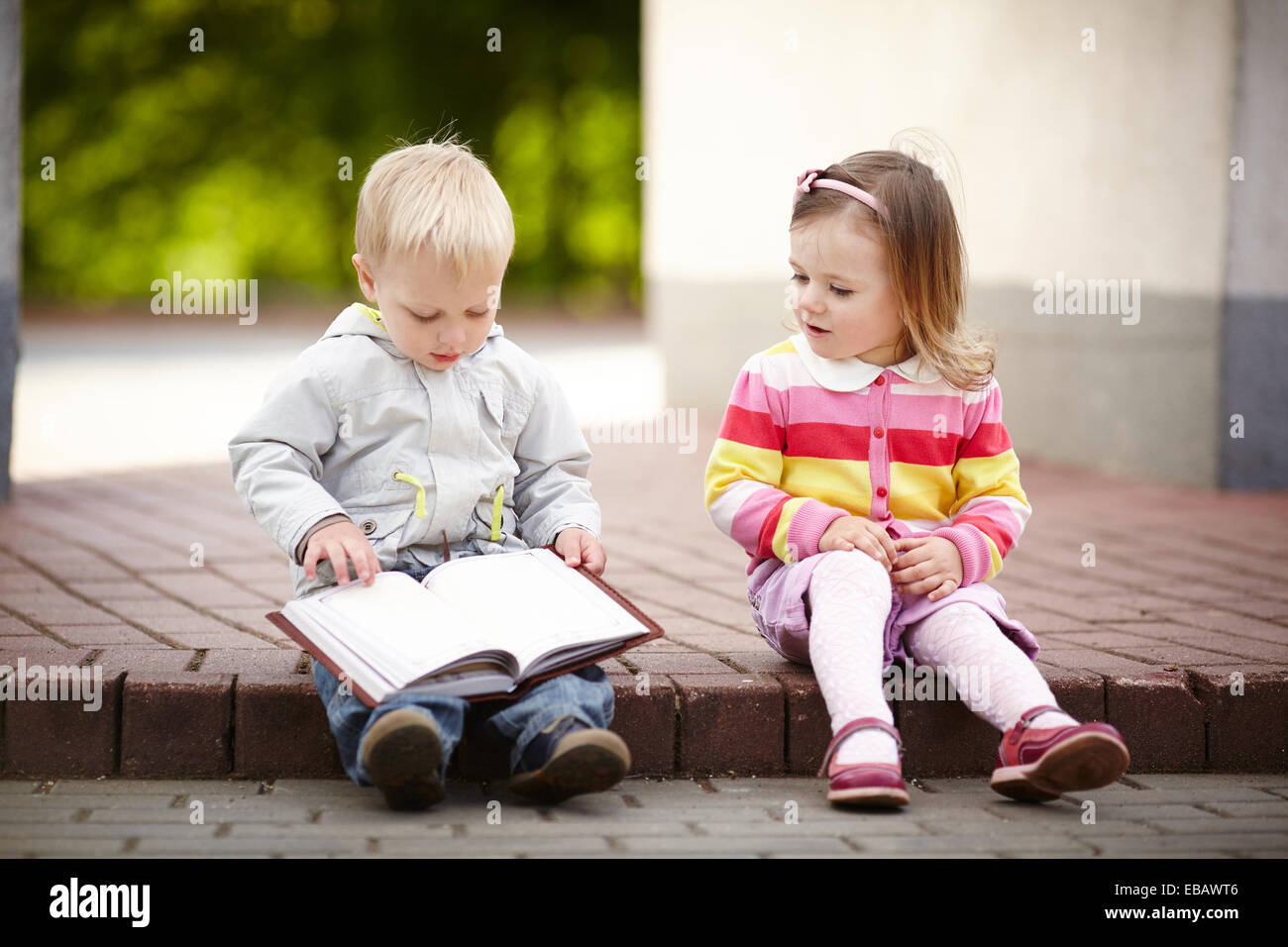 funny boy and girl reading book Stock Photo - Alamy