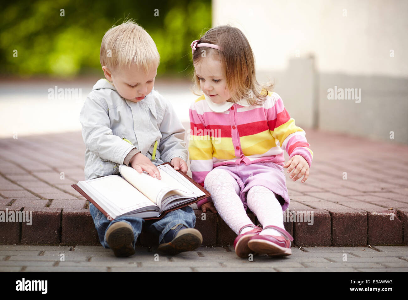 funny boy and girl reading book Stock Photo - Alamy