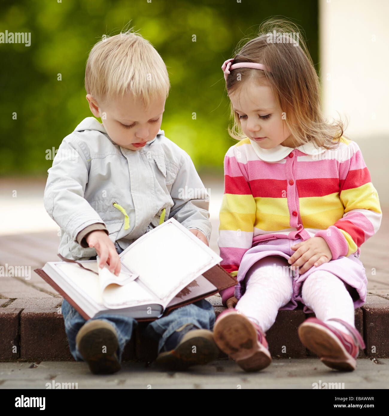 funny boy and girl reading book Stock Photo - Alamy