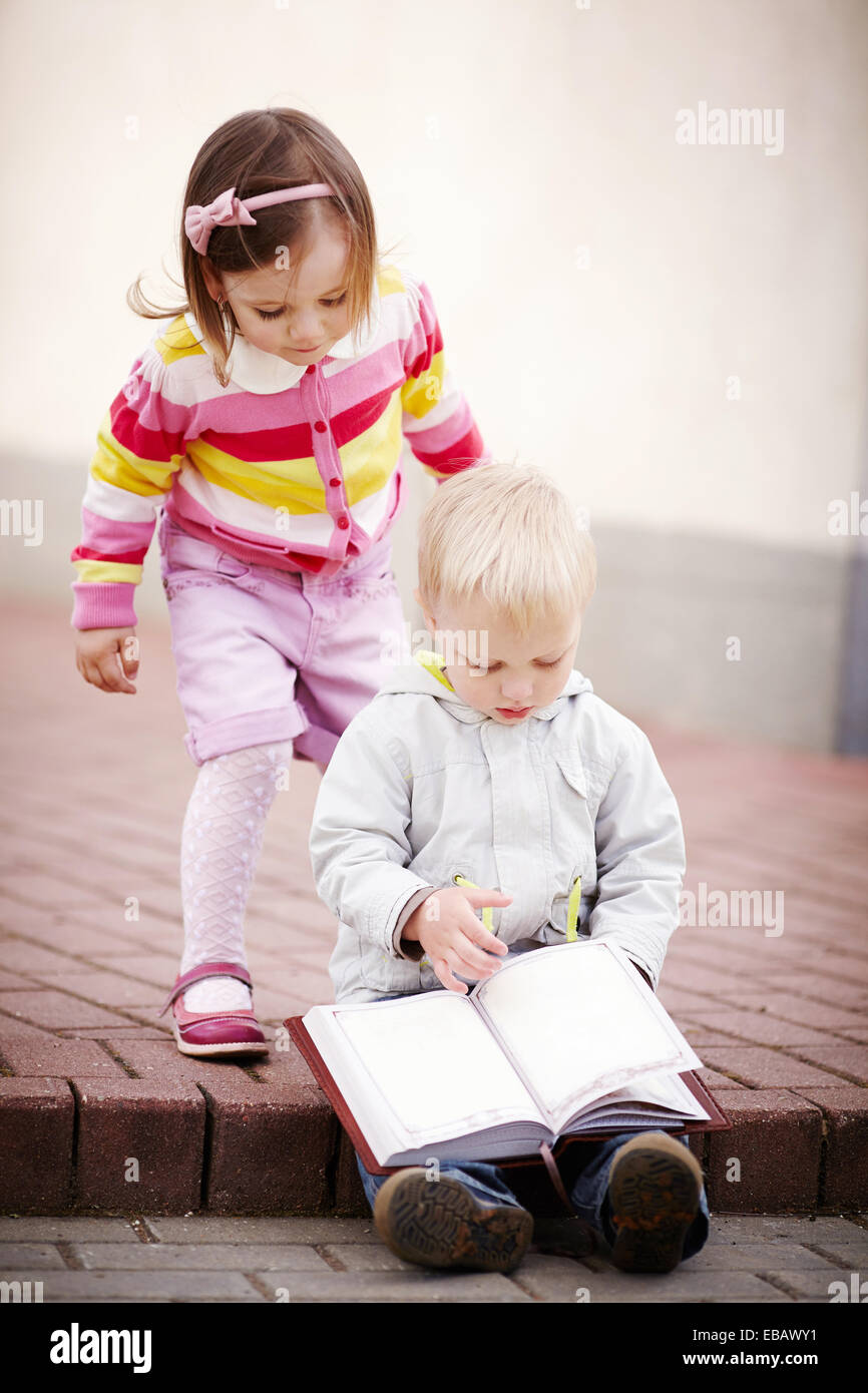 boy and girl reading a book Stock Photo - Alamy