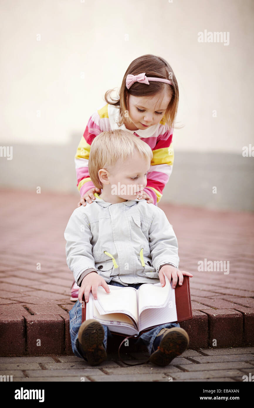 boy and girl reading a book Stock Photo - Alamy