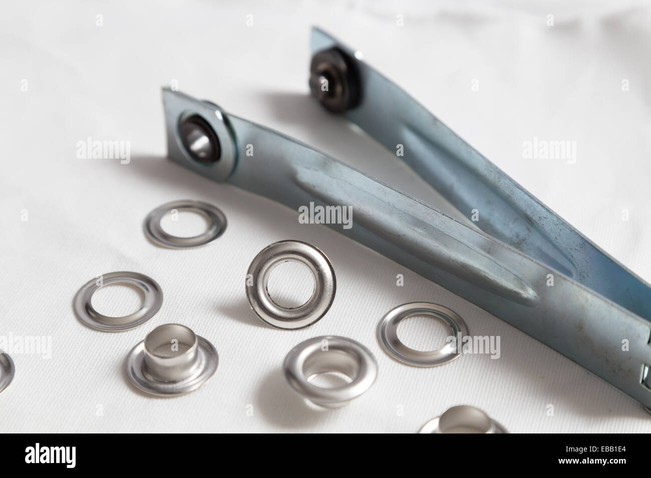 Rivets on light white cloth Stock Photo - Alamy