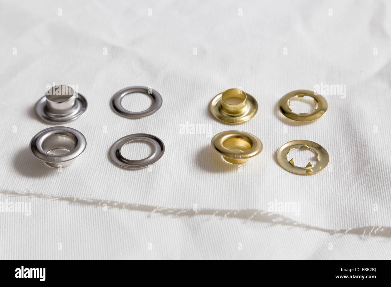 Rivets on light white cloth Stock Photo - Alamy