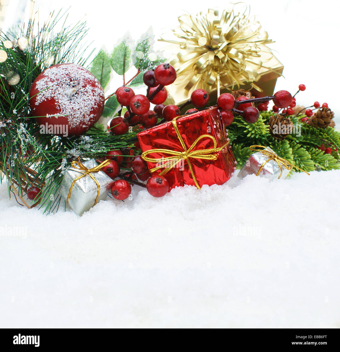 Christmas gifts and decorations nestled in snow Stock Photo - Alamy