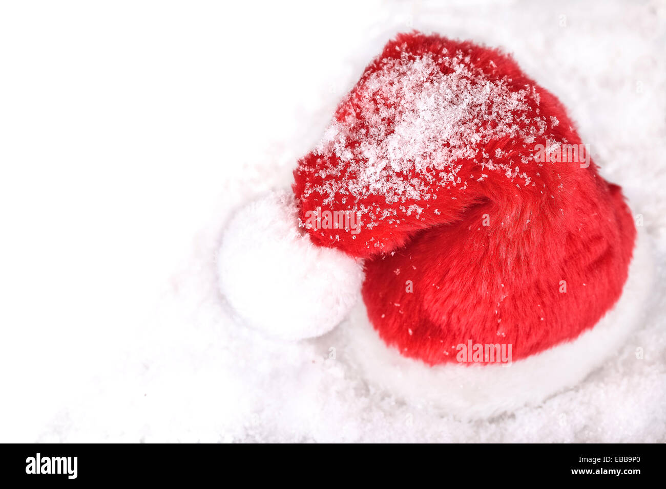 Santa Claus hat on the snow Stock Photo - Alamy