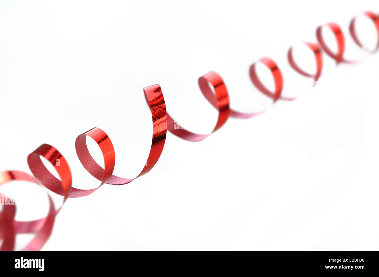 curling red gift ribbon on white background Stock Photo - Alamy