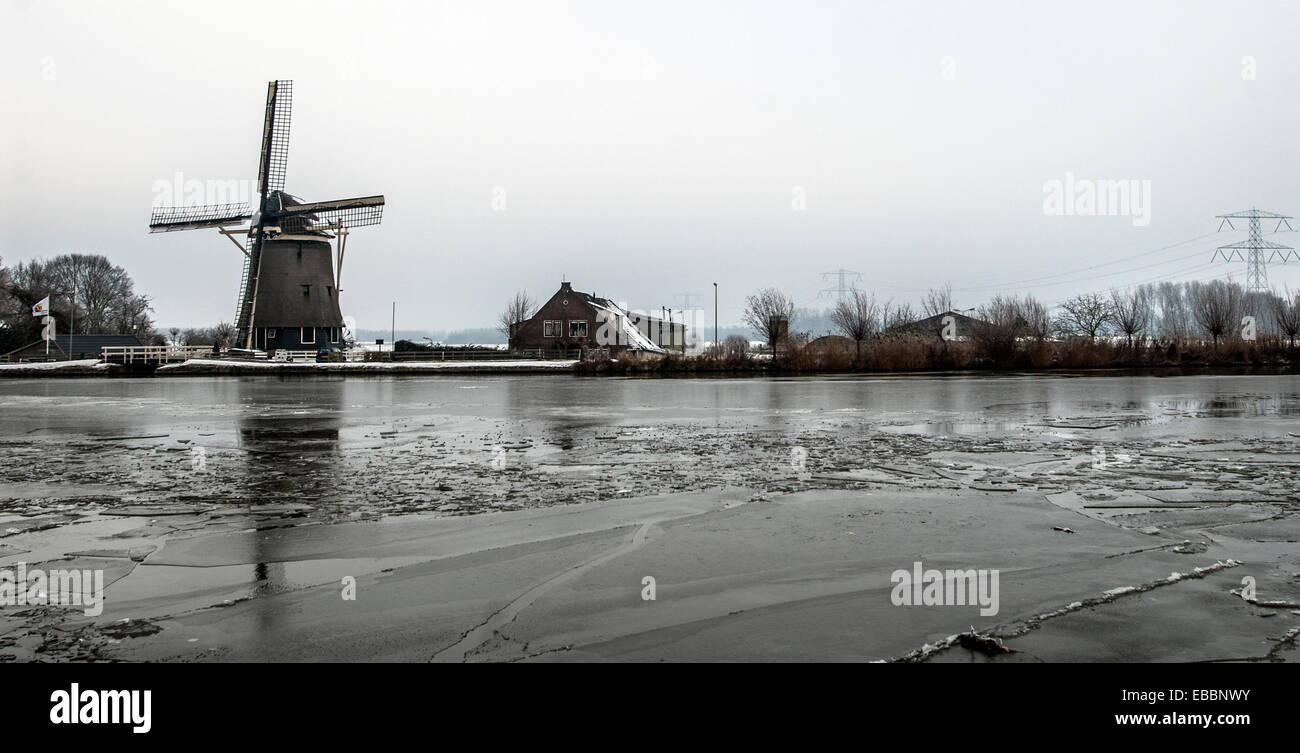 Dutch windmill in scenic winter landscape with frozen canal Stock Photo ...