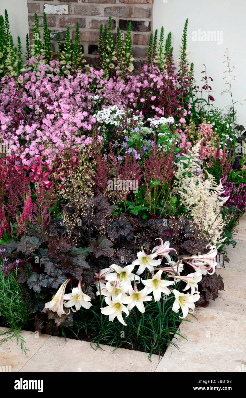 A full and colourful flower border in a contemporary garden Stock Photo ...