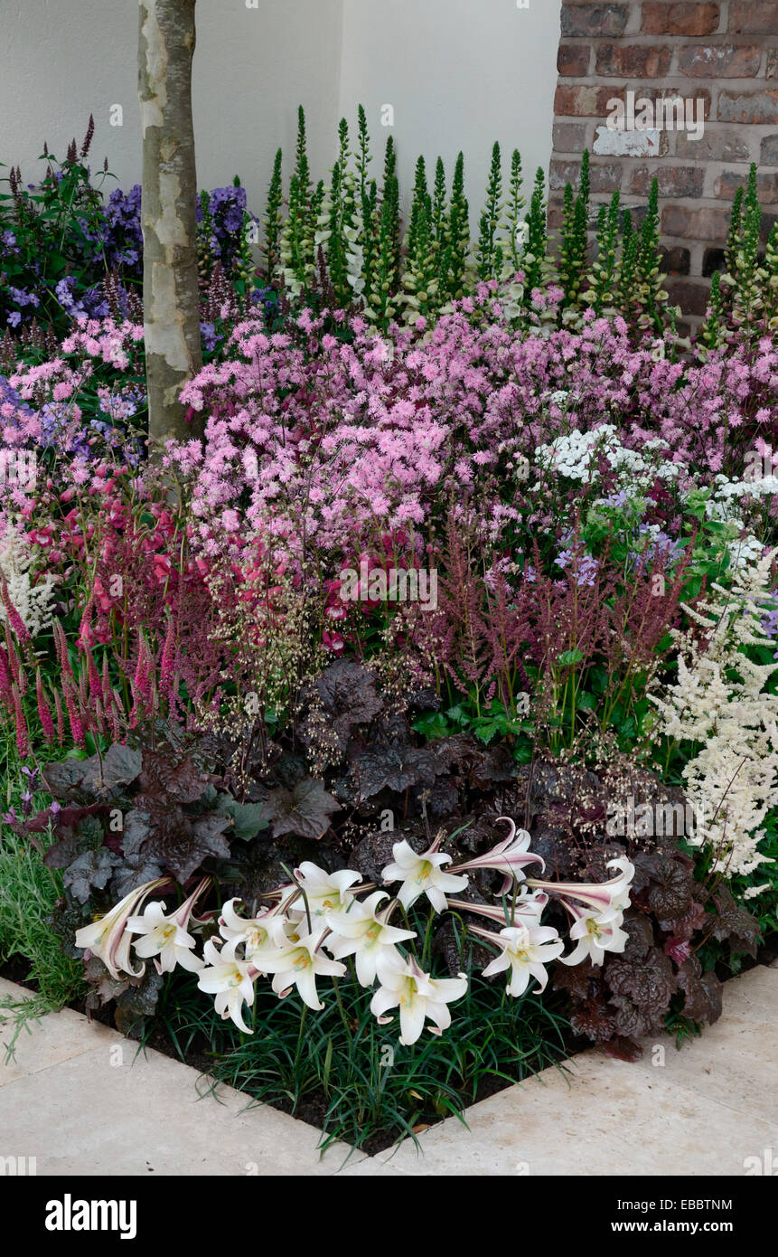A full and colourful flower border in a contemporary garden Stock Photo ...