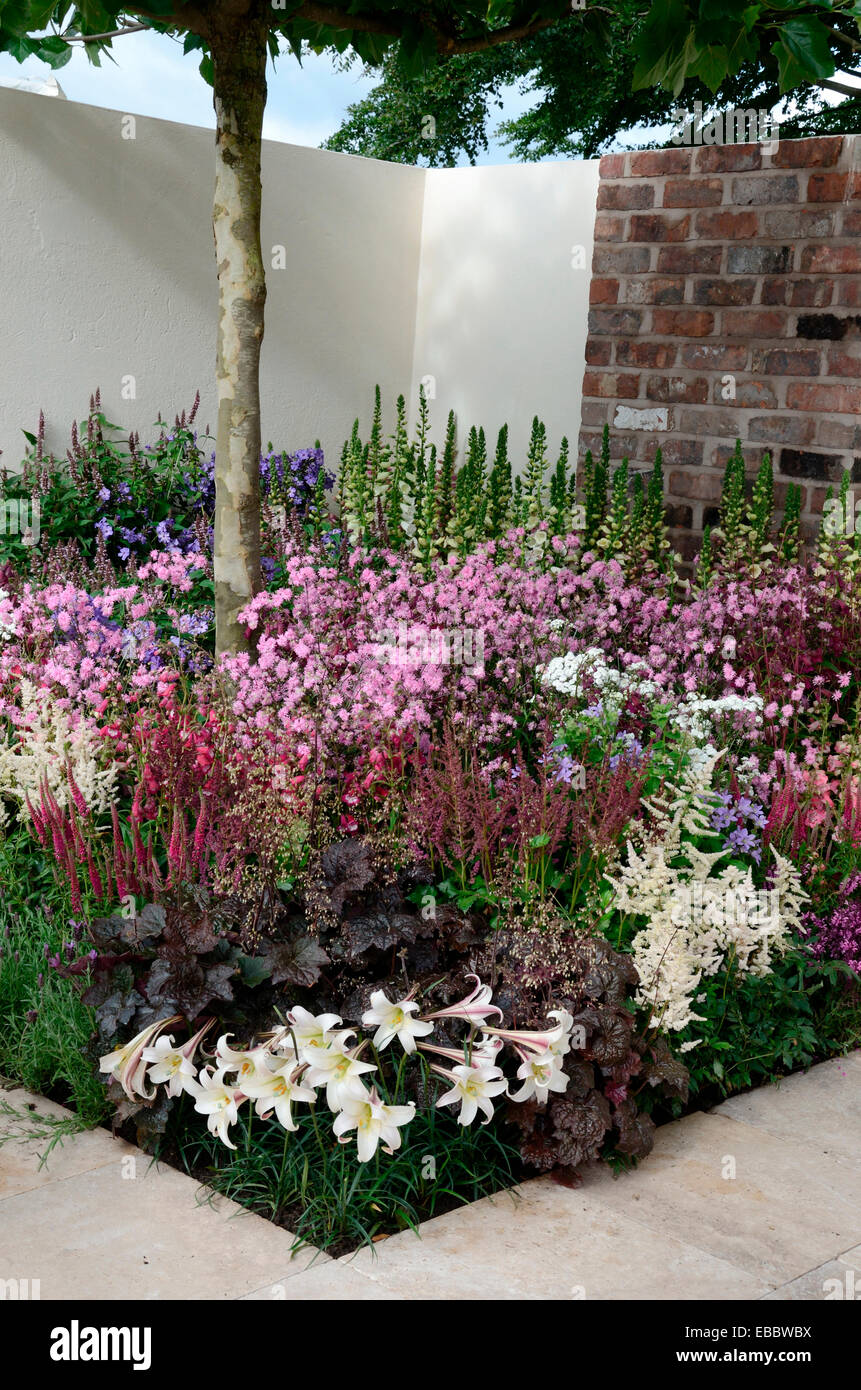 A full and colourful flower border in a contemporary garden Stock Photo ...