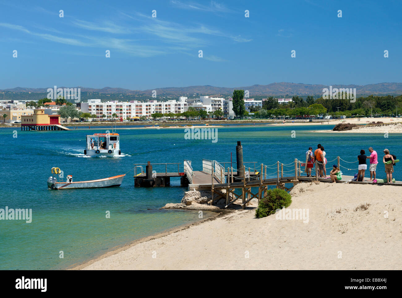 The ferry taking tourists to the main island beach over the lagoon ...