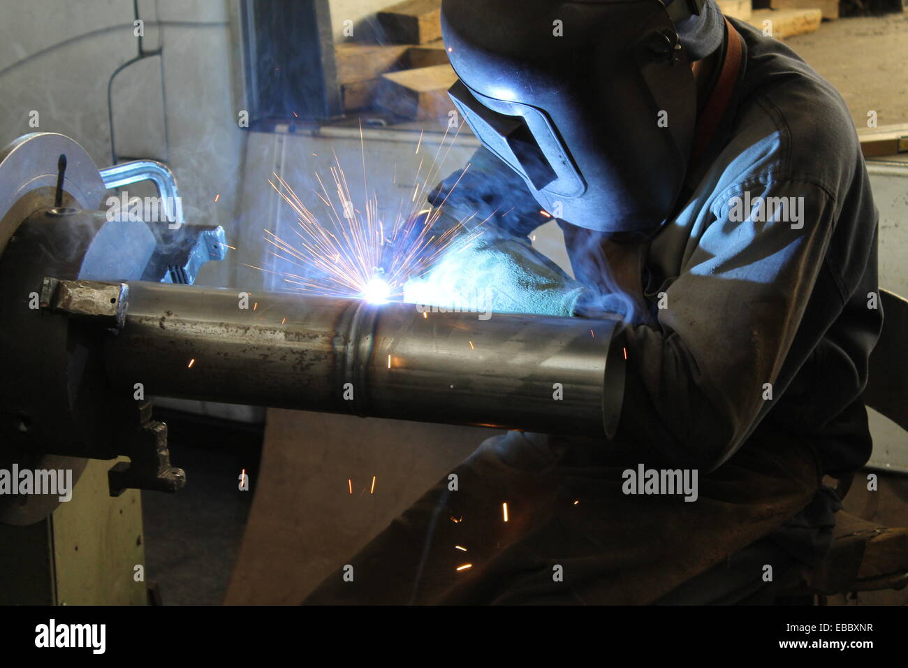 Industrial welder welding on steel in factory Stock Photo - Alamy