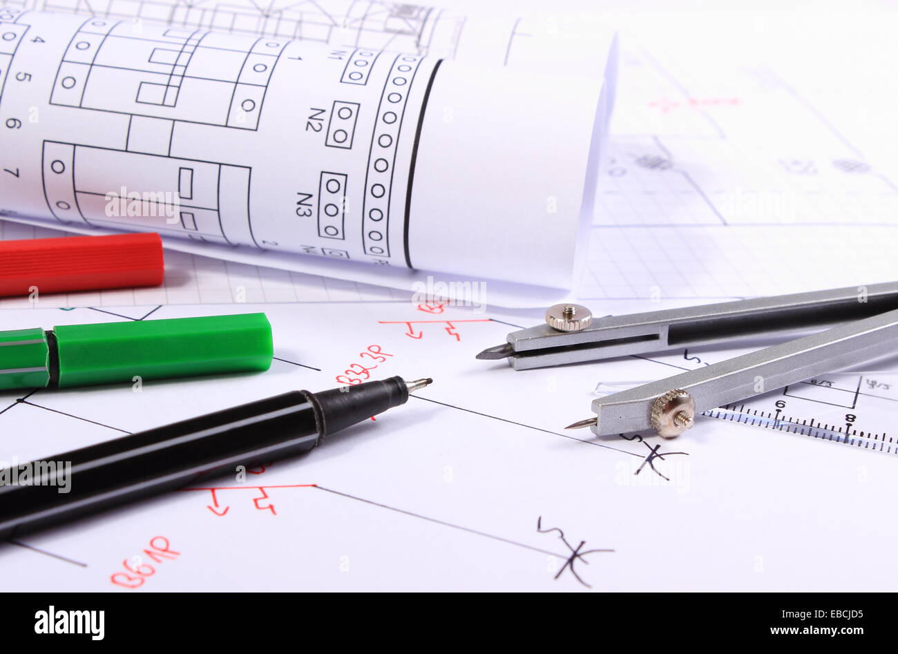 Rolls of electrical diagrams and accessories for drawing lying on ...