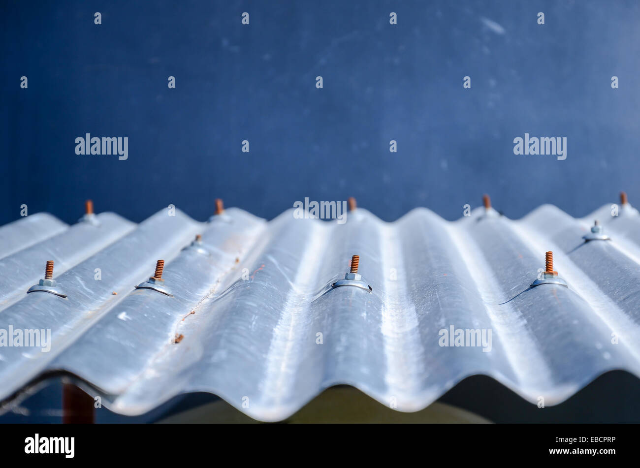 Details of red rivets of a tin roof on a blue background Stock Photo ...