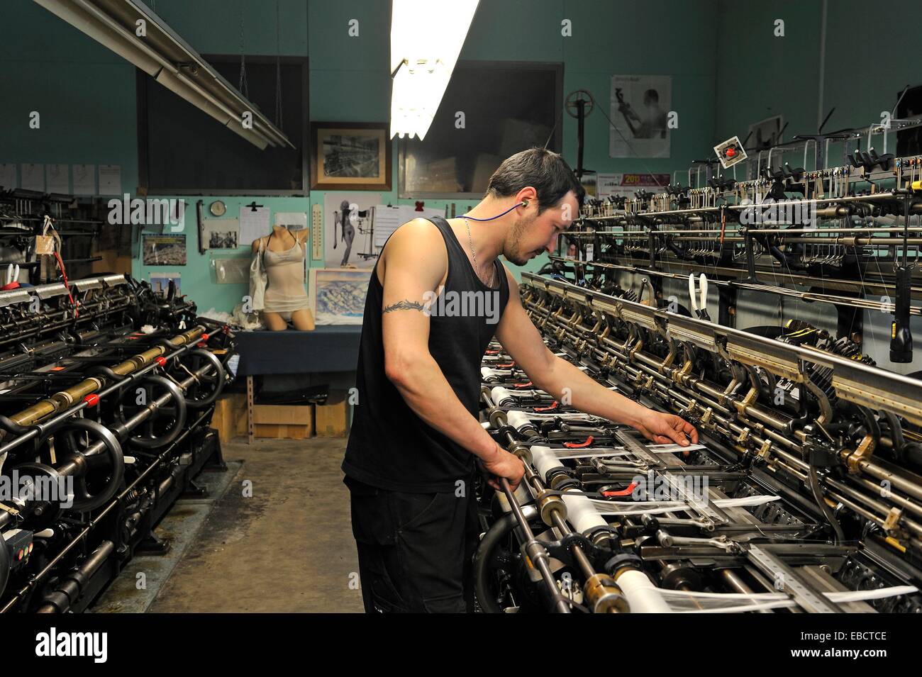 skilled worker in charge of the old weaving looms in the luxury silk ...